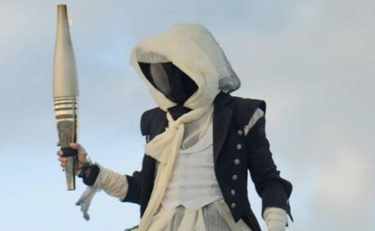 All that is known about the mysterious figure carrying the Olympic ...